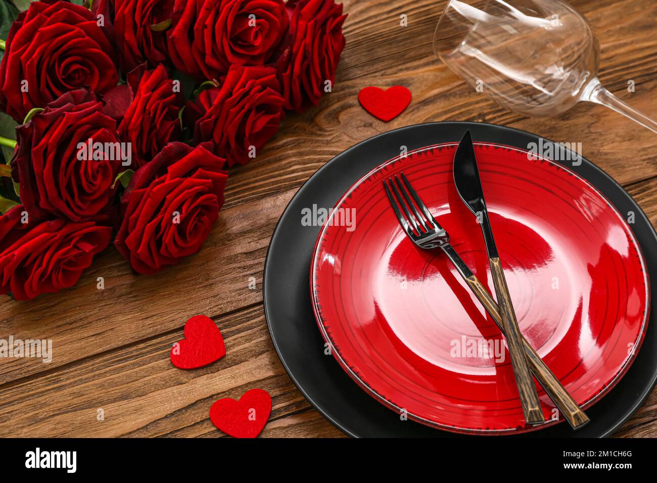 Table setting for Valentine's Day with hearts and roses on wooden ...