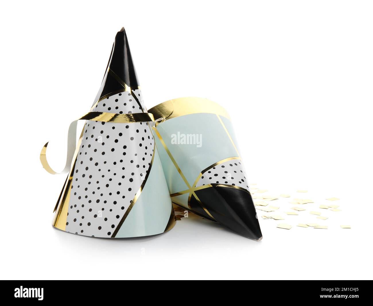 Stylish party hats with confetti on white background Stock Photo - Alamy