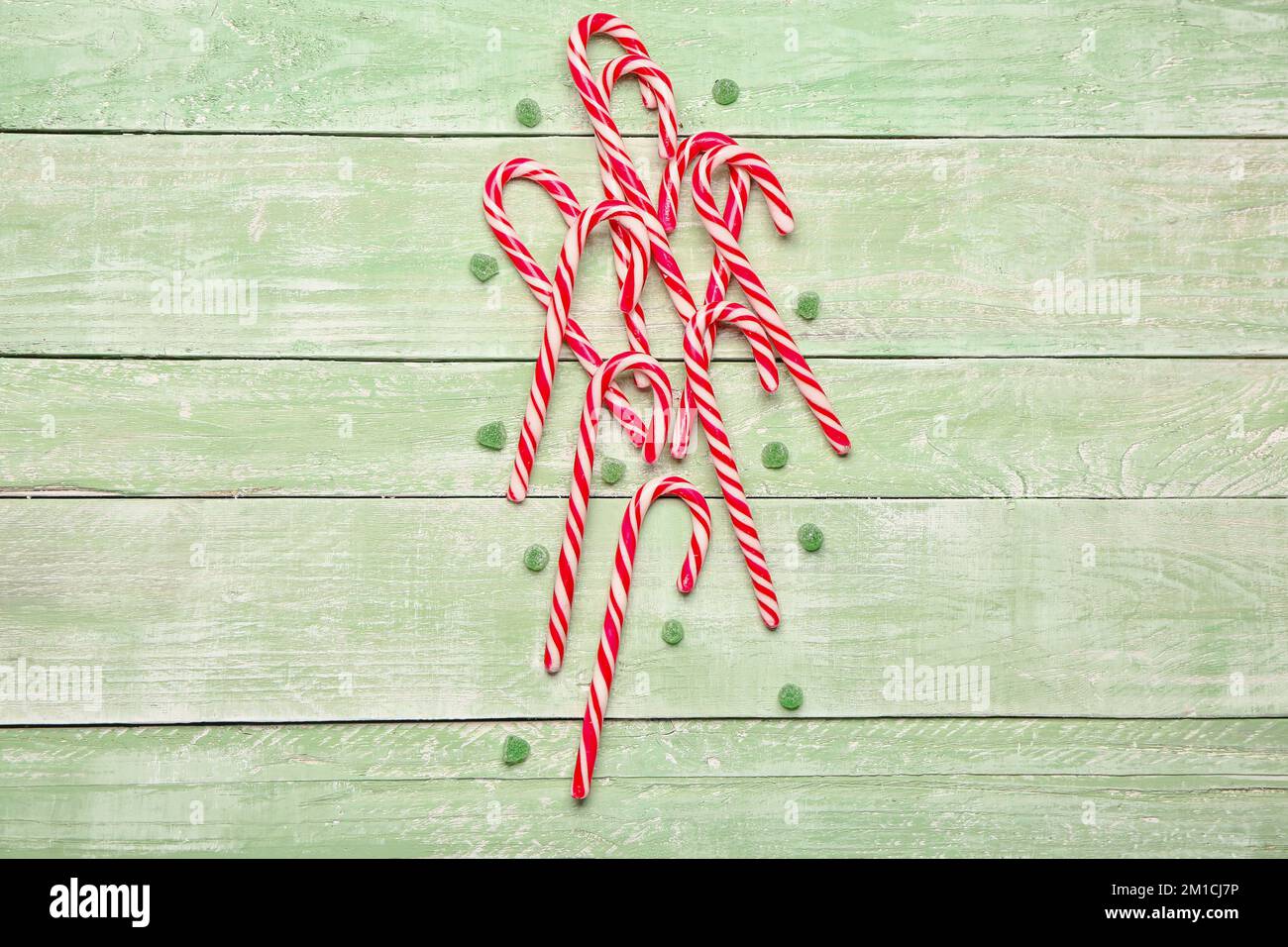 Composition with tasty candy canes on color wooden background Stock ...