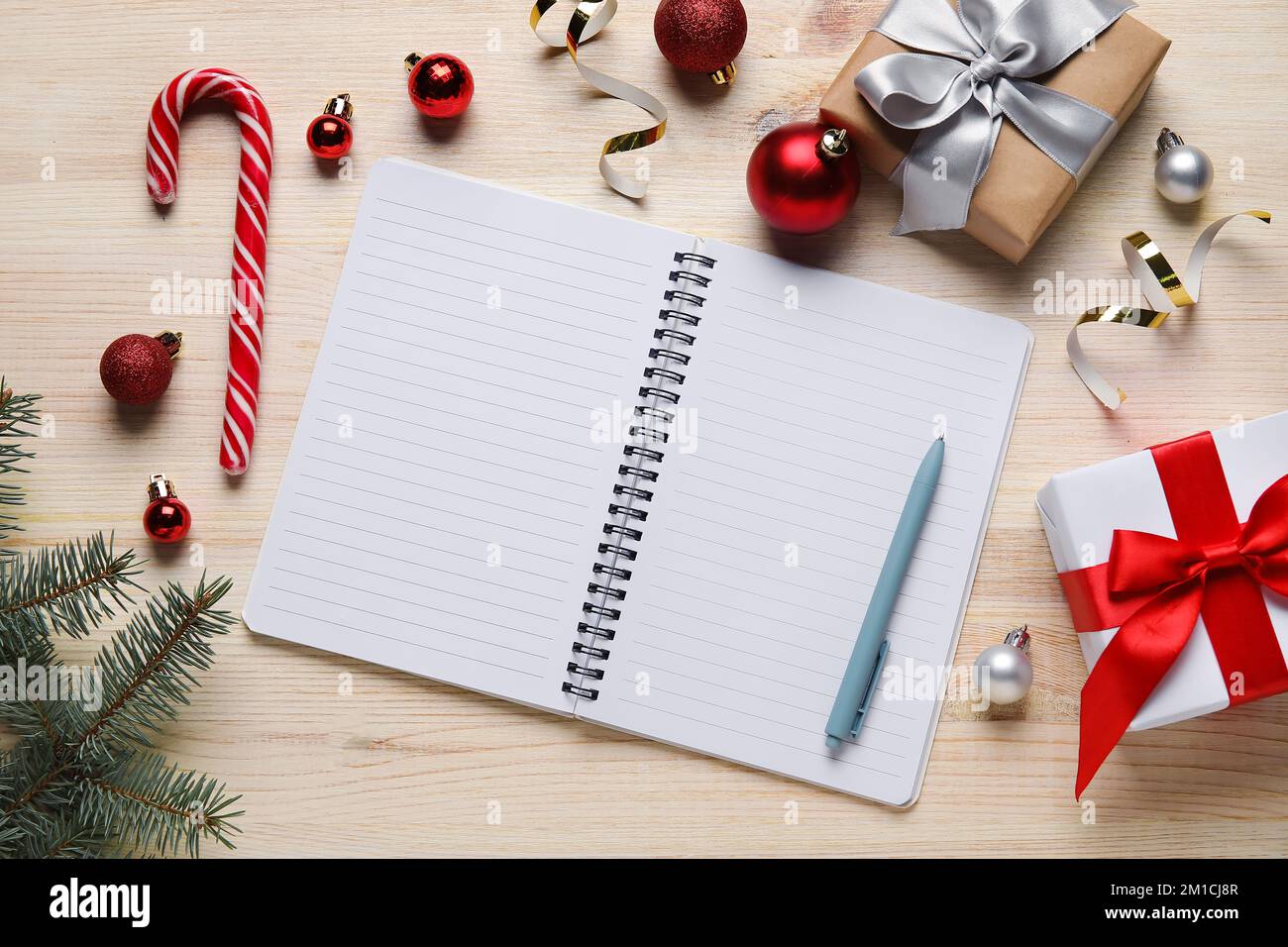 Composition with blank open notebook, pen, Christmas decorations and ...
