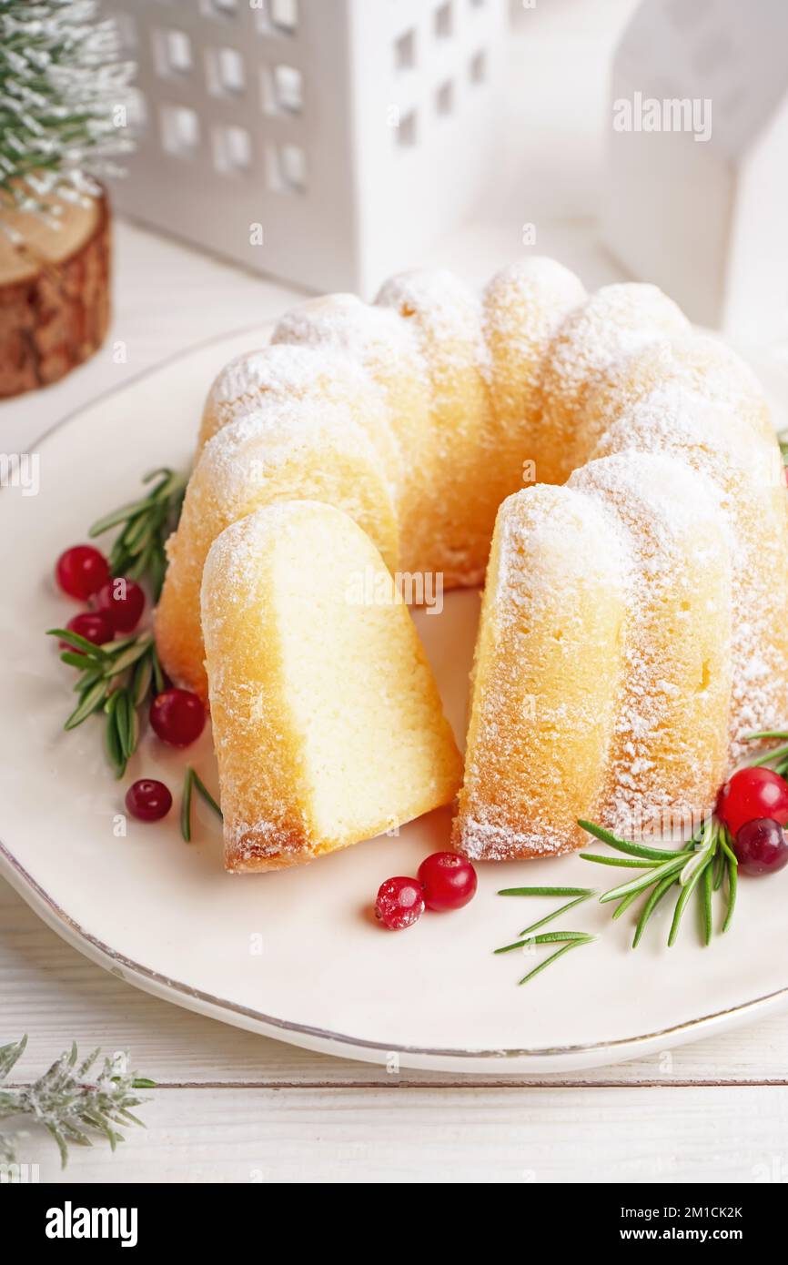 Plate with tasty Christmas cake on light wooden table, closeup Stock ...