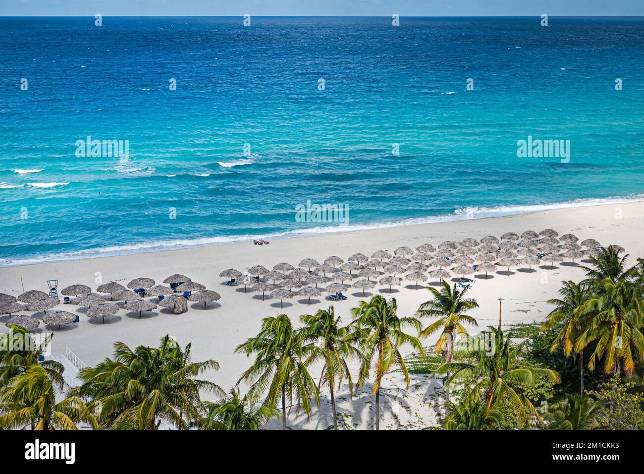 Straw umbrellas on Paradise beach in the Caribbean with white sand and ...