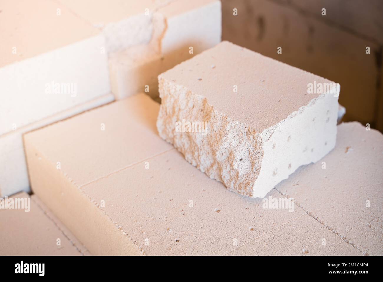 Poor-quality brittle aerated concrete close-up at the place of spalling ...