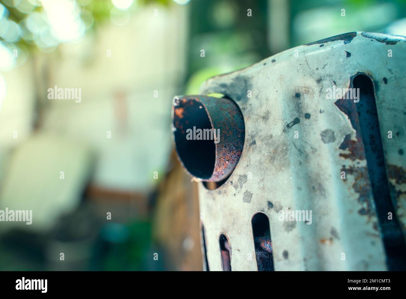 Exhaust pipe of a walk-behind tractor close-up on a blurred background ...