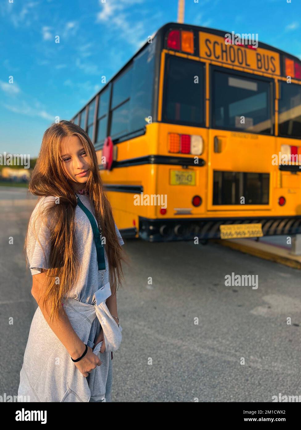 Beautiful teen girl getting on school bus Stock Photo - Alamy