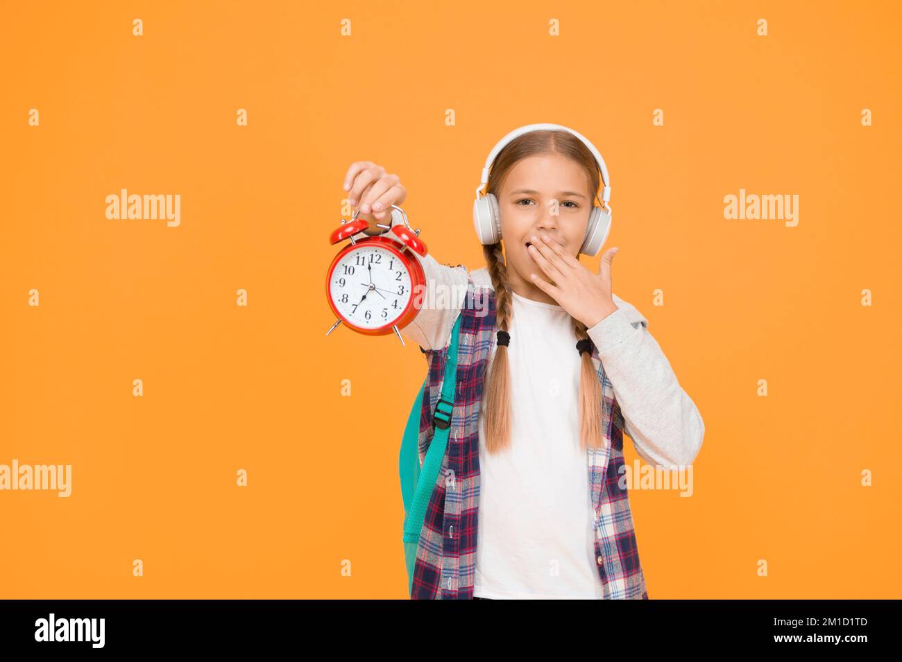 Classes schedule. Schoolgirl hold alarm clock yellow background. School ...