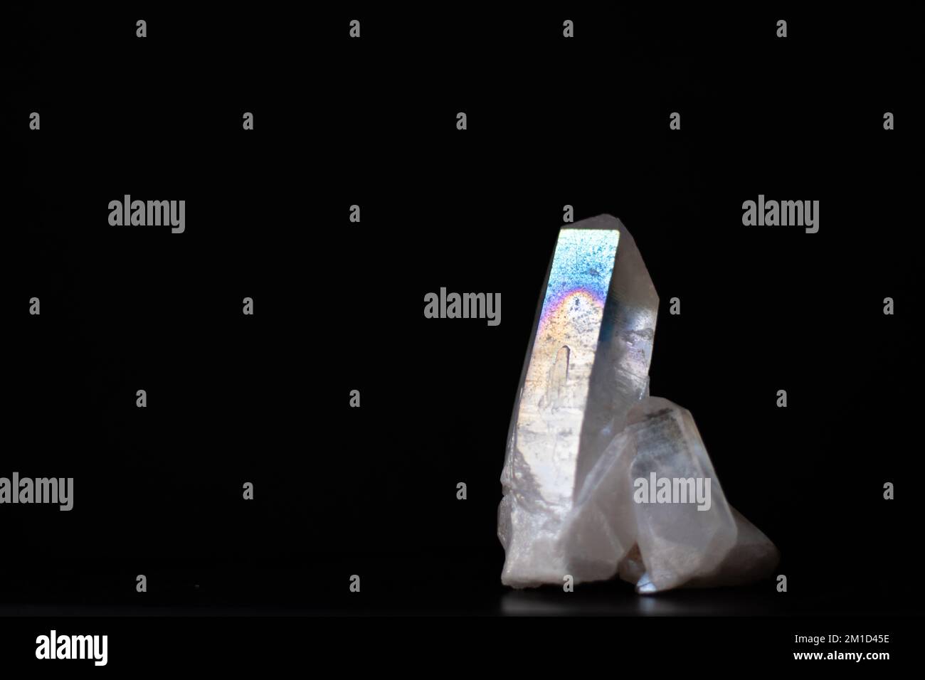 A closeup shot of an angel aura stone reflecting colors against the ...