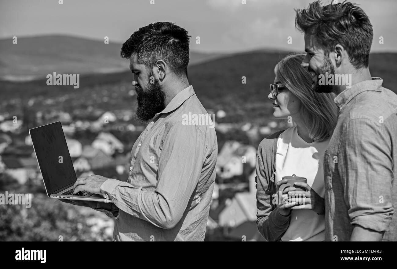 Colleagues with laptop work outdoor sunny day, nature skyline ...