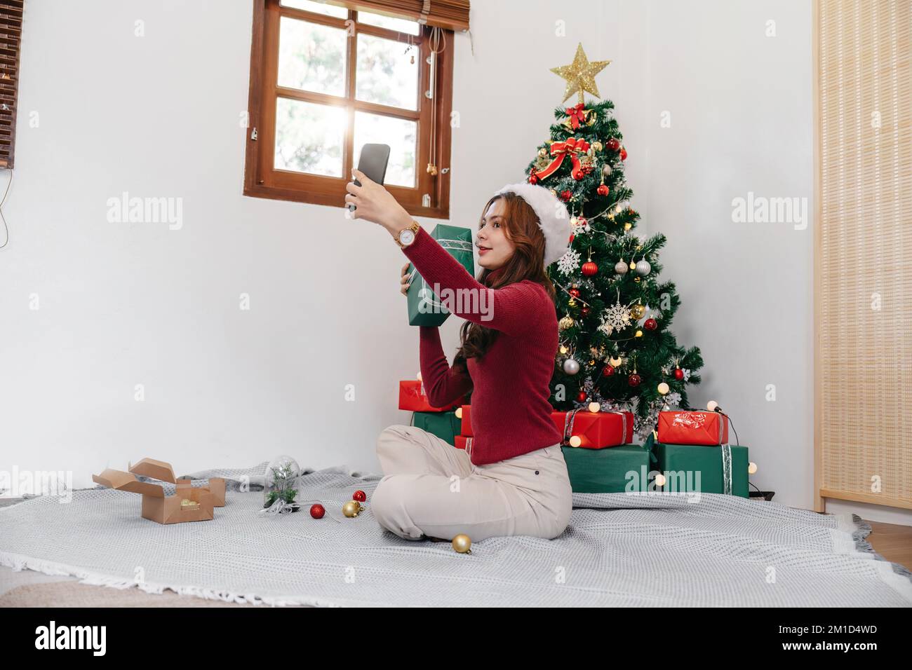Holiday selfie at Christmas tree. Happy young girl taking selfie on ...