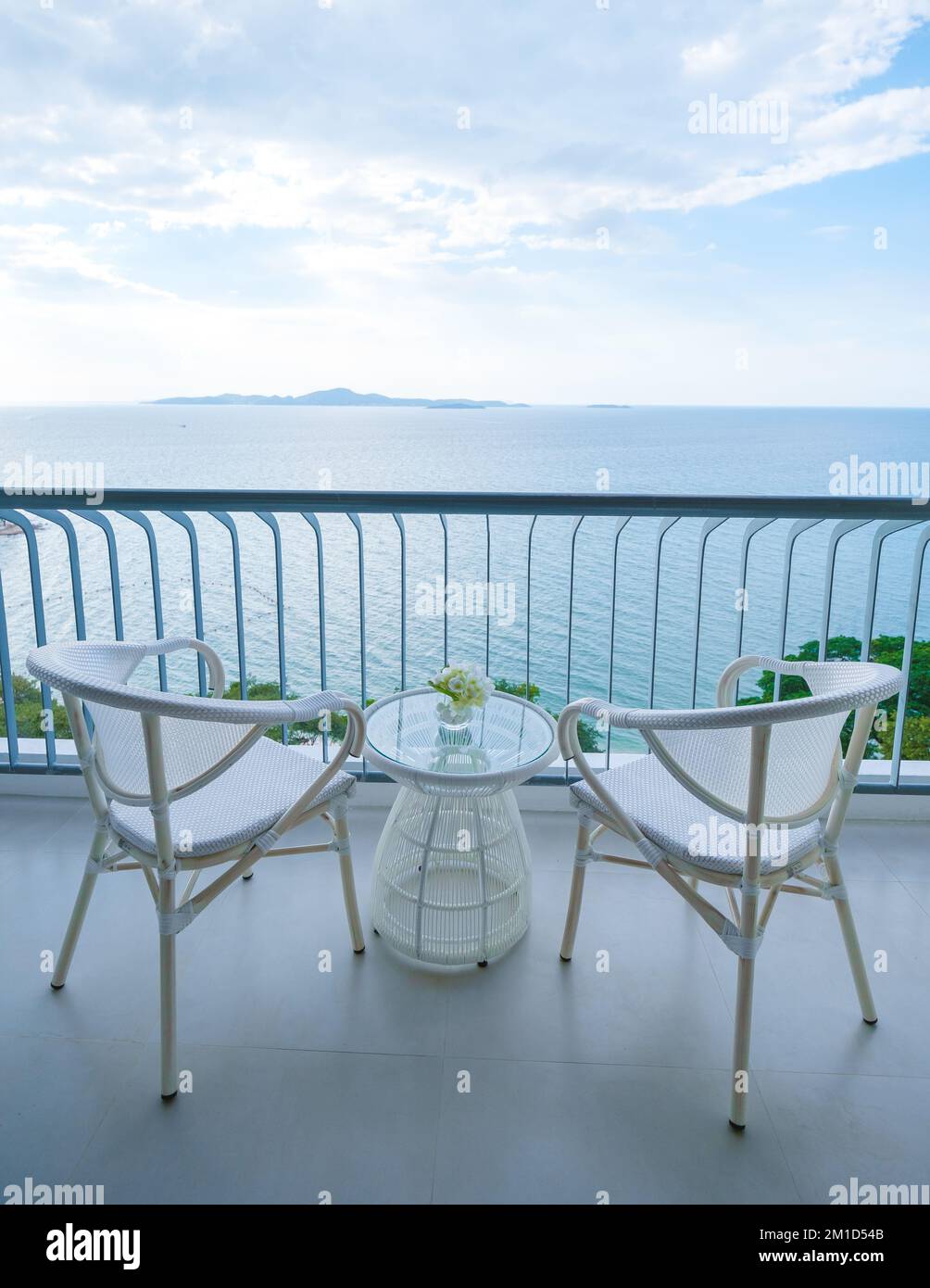 Chairs on the balcony with a view at the blue ocean on a balcony of a ...