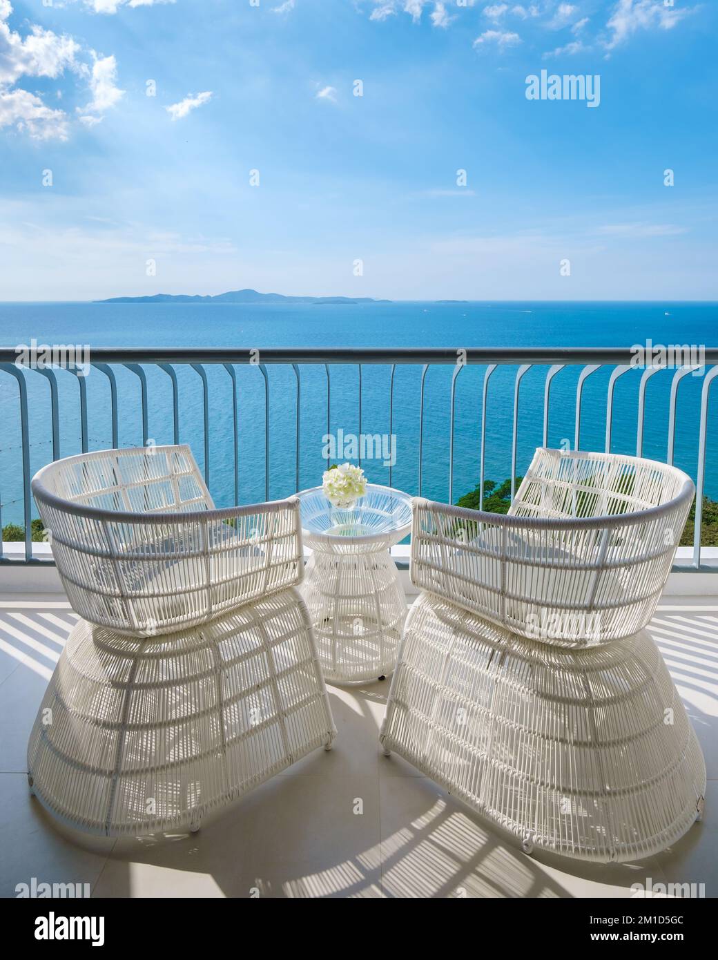 Chairs on the balcony with a view at the blue ocean on a balcony of a ...