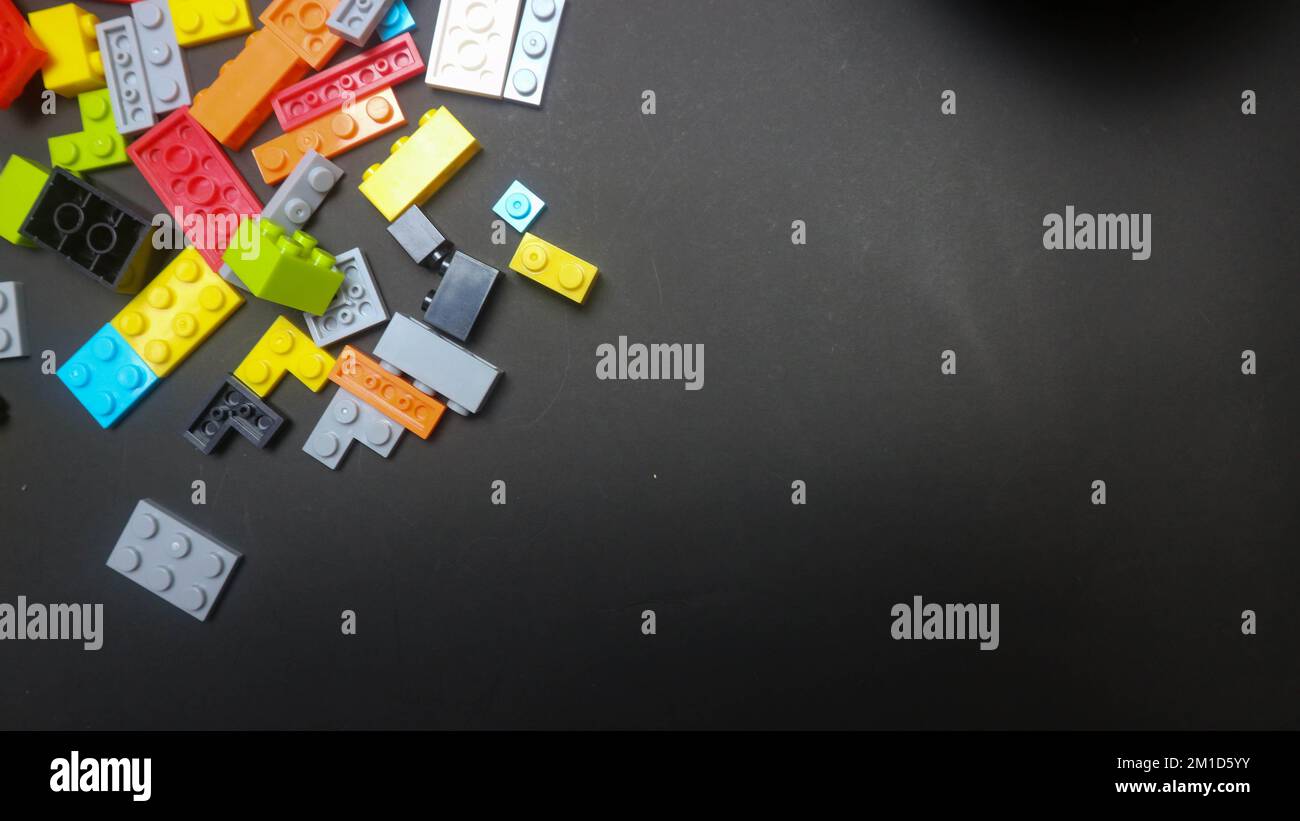 Plastic toy blocks on black background Stock Photo - Alamy