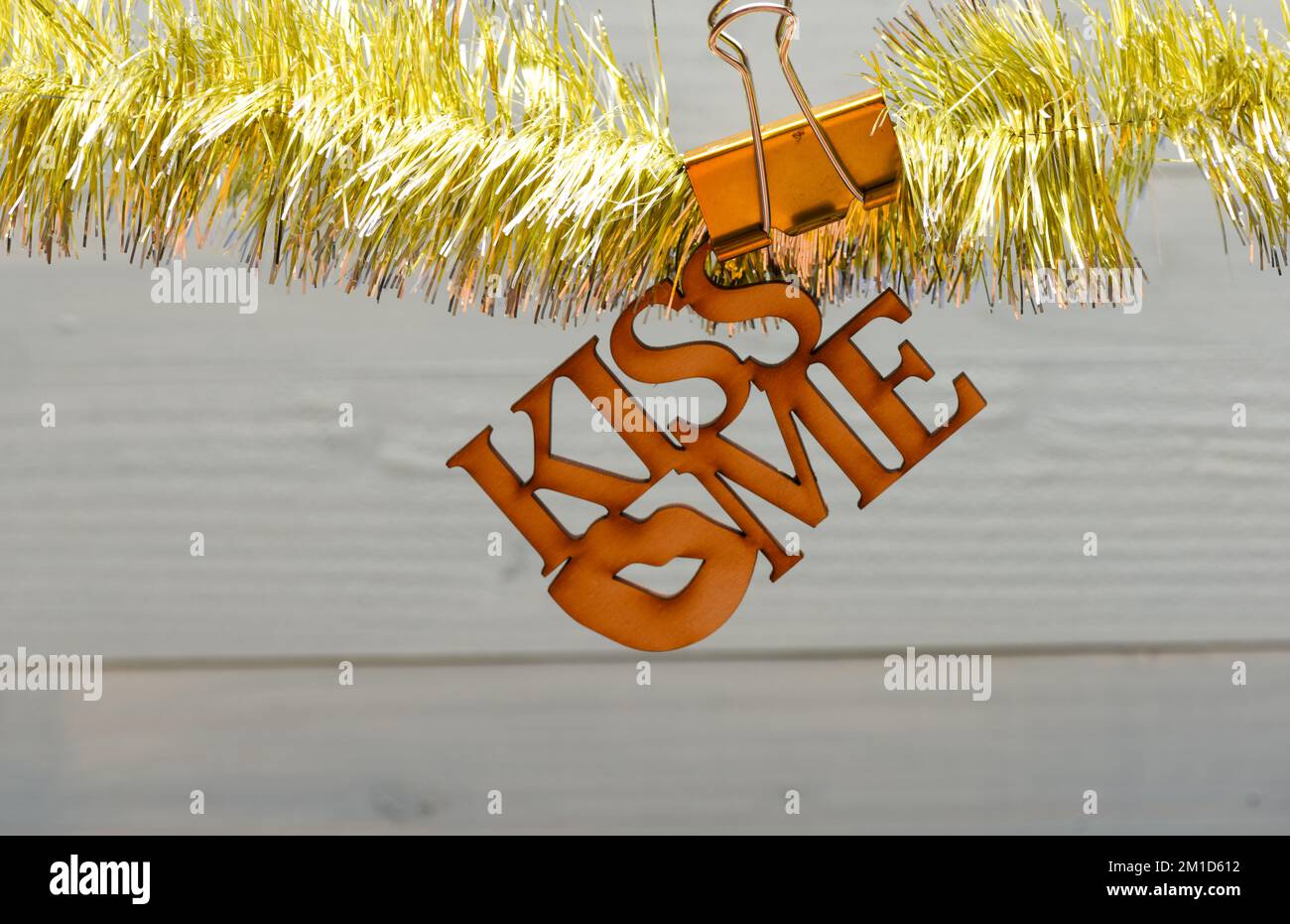 Tinsel with christmas ornaments and blank paper note wooden background ...