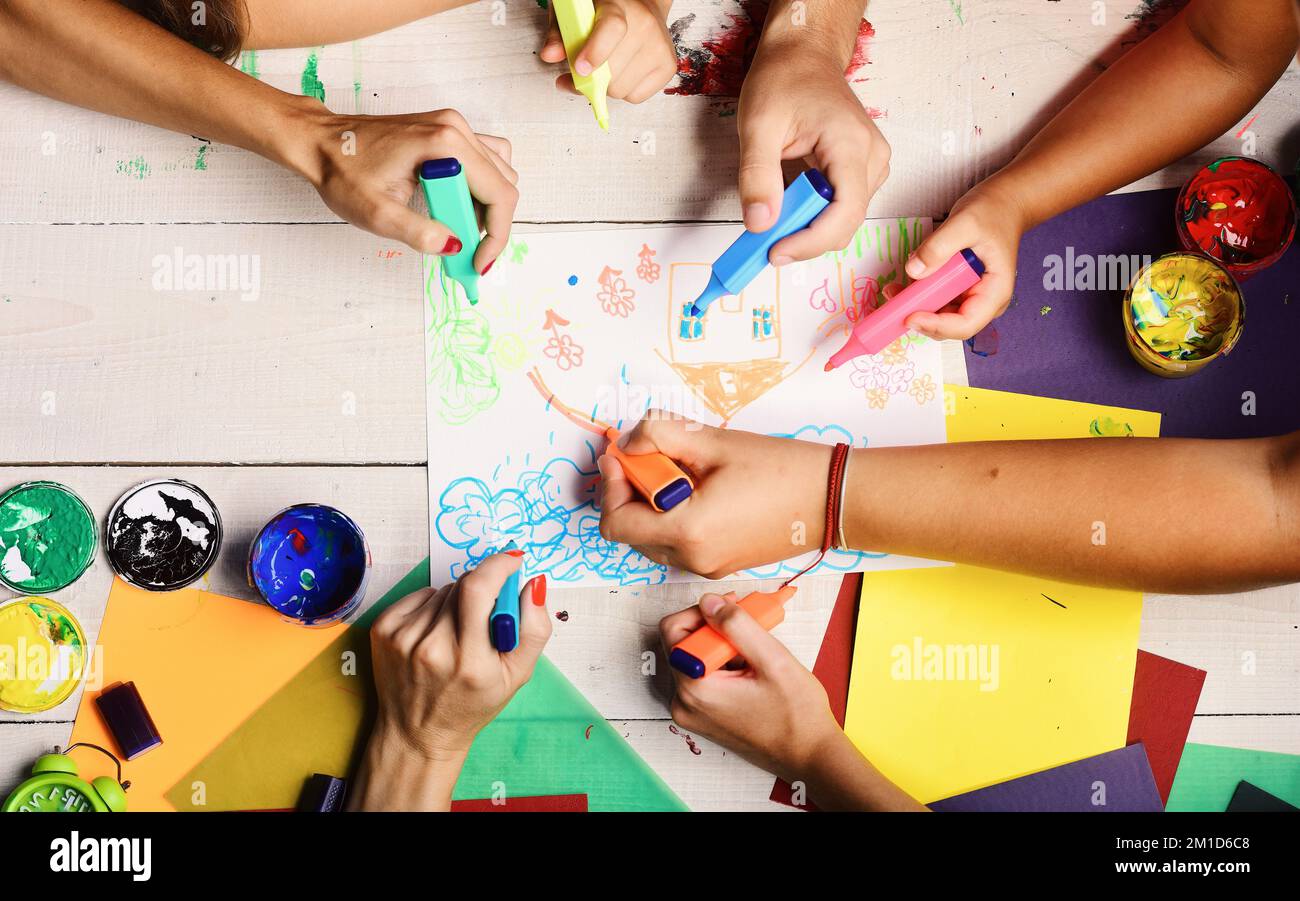 Hands hold colorful markers and draw kids illustration Stock Photo - Alamy
