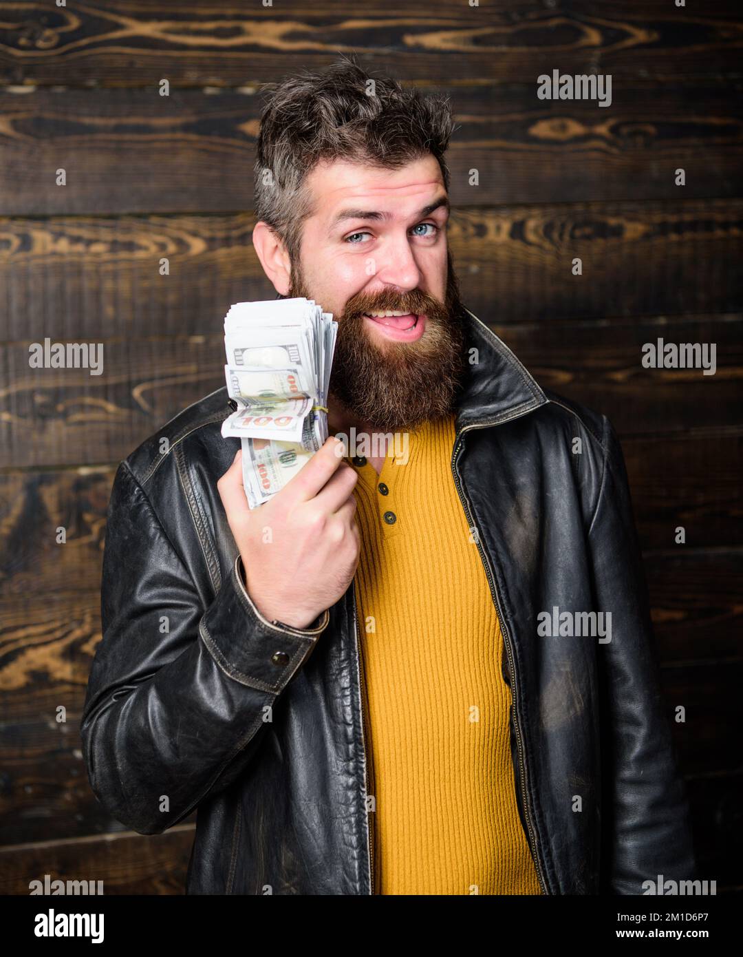 Man brutal bearded hipster wear leather jacket and hold cash money ...