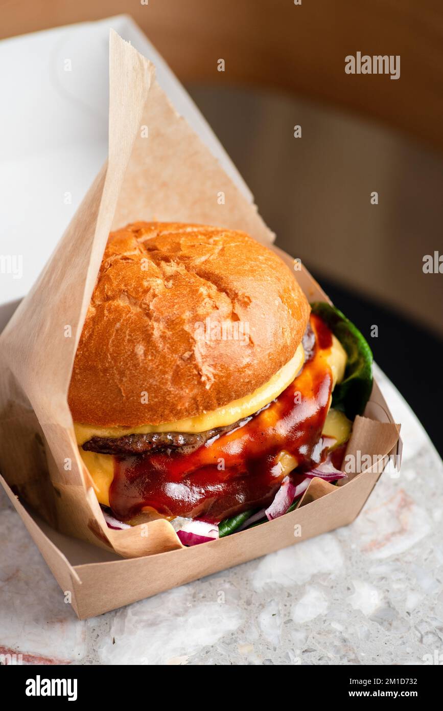 Double cheeseburger with a lot of sauces on gray stone background ...