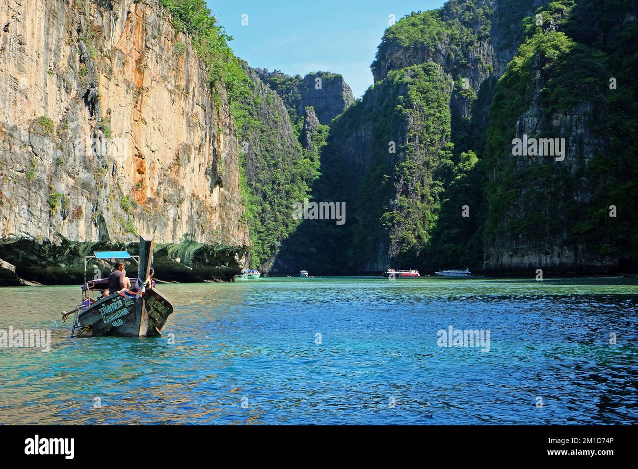 Long tail boat with natural landscape of green mountain cliff and ...