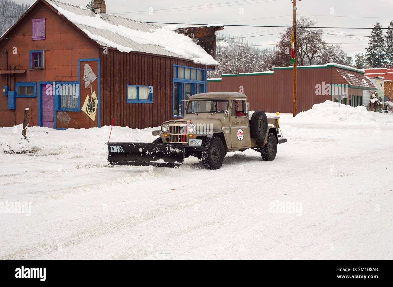 A 1962 Kaiser Willys Jeep pickup truck plowing snow in Troy, Montana ...