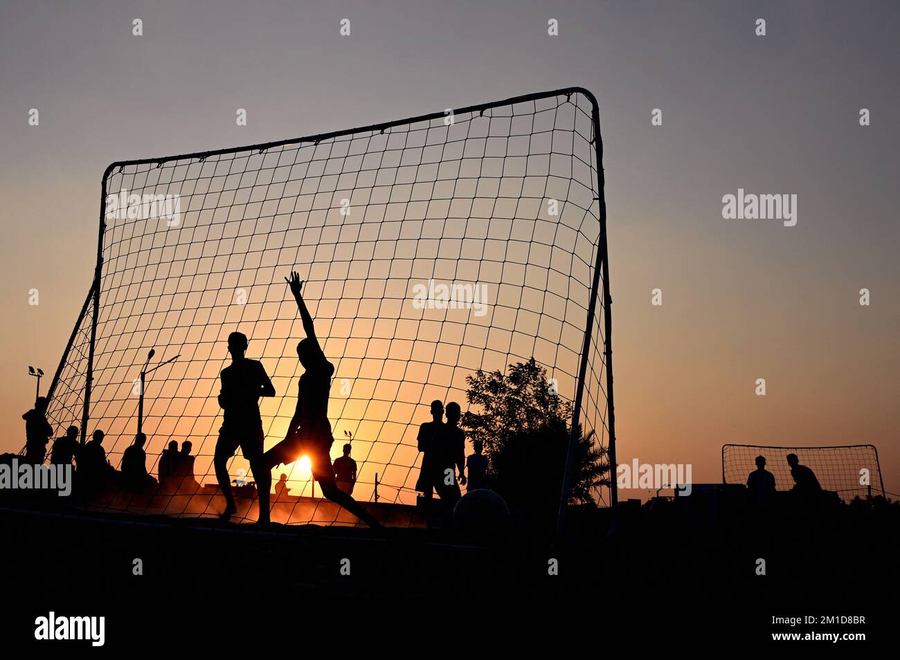 Beach soccer at sunset at Katara Beach Doha Stock Photo - Alamy