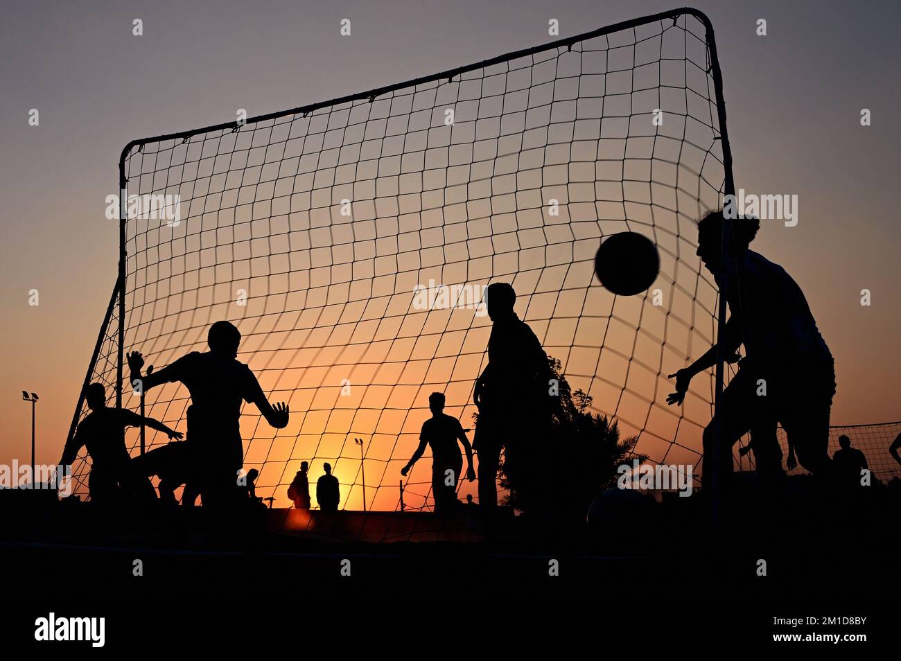 Beach soccer at sunset at Katara Beach Doha Stock Photo - Alamy