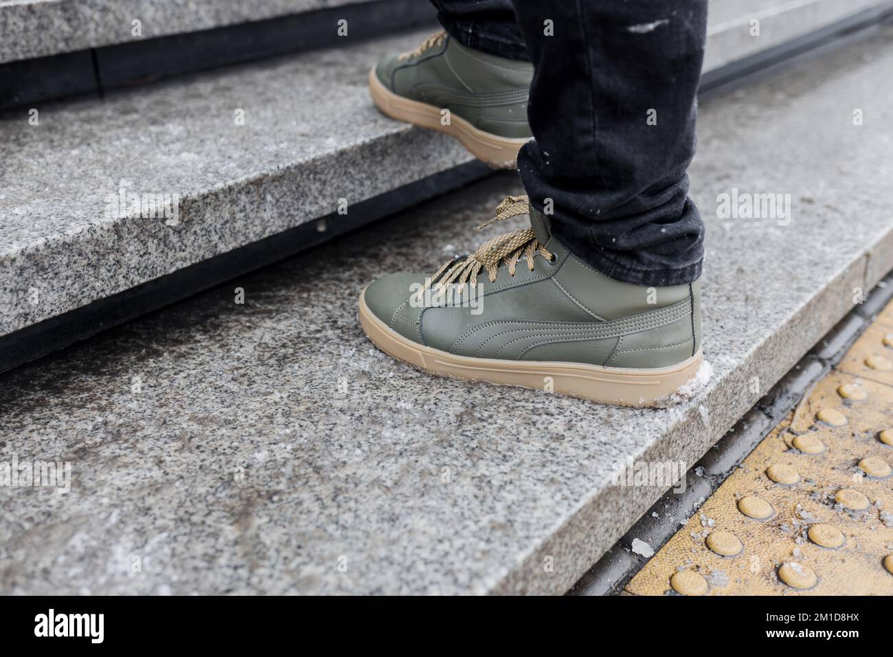 Male sneakers or shoes with black jeans on men's legs on stairs Stock ...