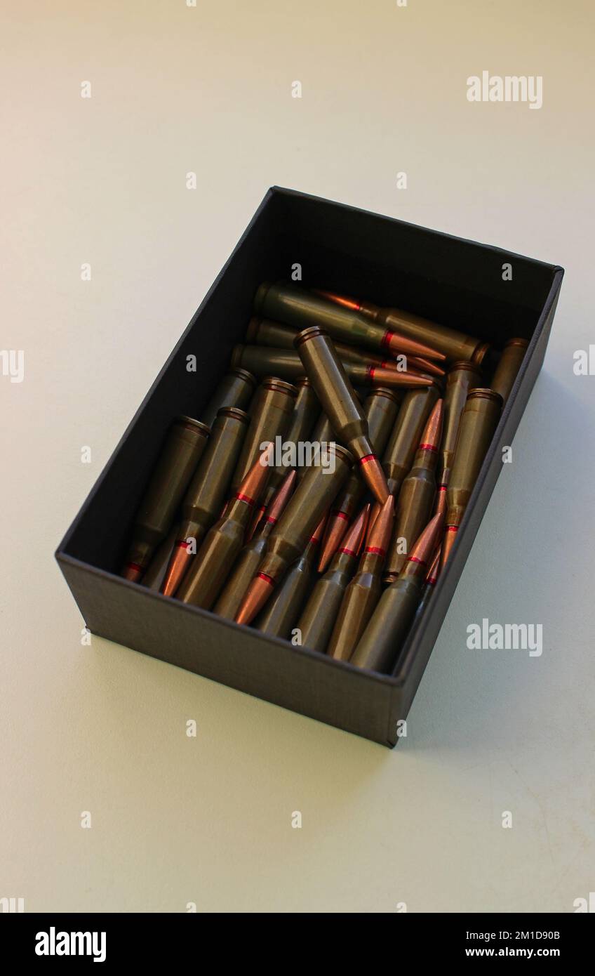 Black Case With Scattered Bullets On A White Surface Vertical Photo ...