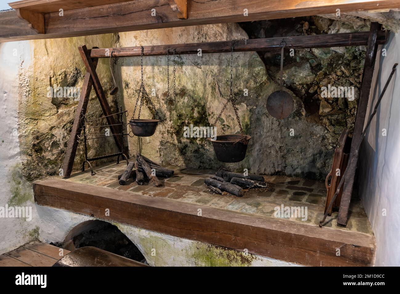 Hanging cauldrons in medieval kitchen in Predjama Castle interior in ...