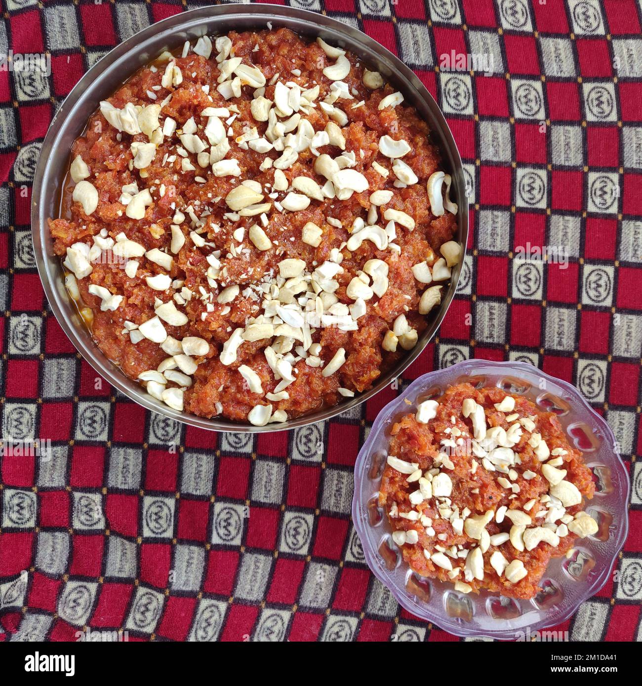 A top view of Gajar halva with carrot, cashew, and pistachio nuts in ...