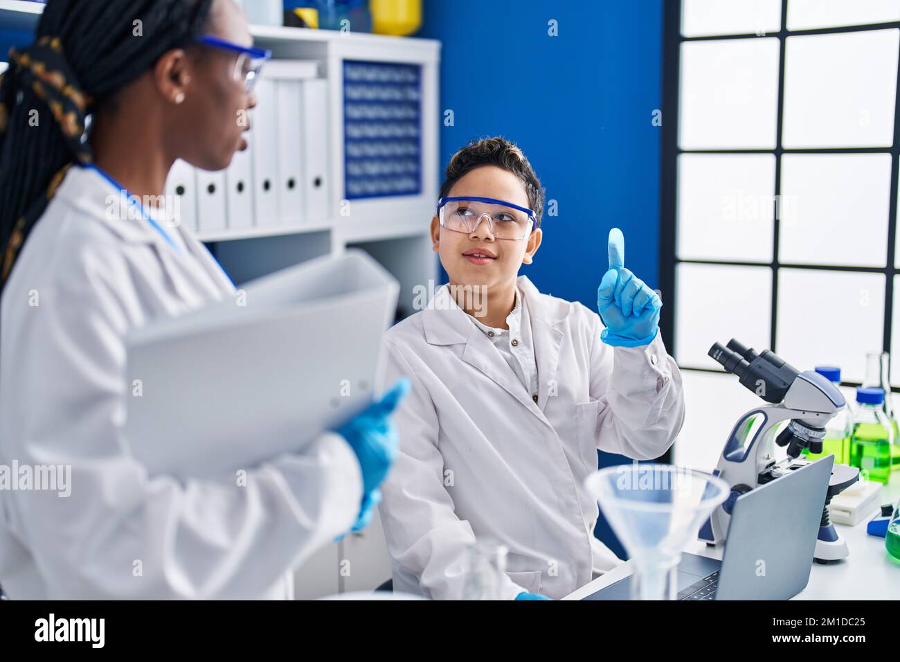 African american mother and son scientists smiling confident doing idea ...
