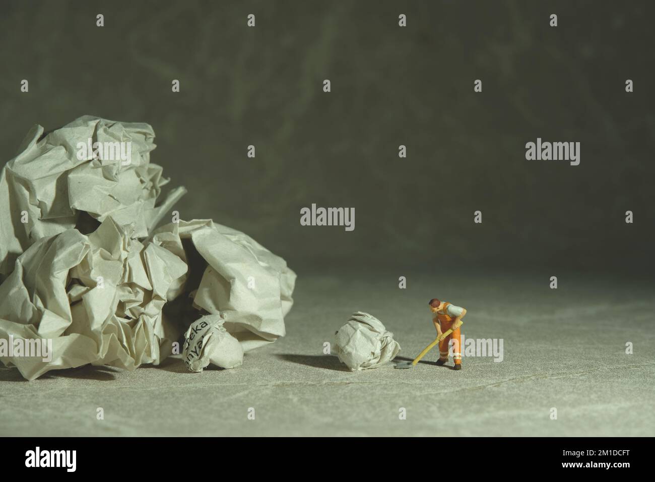 Miniature people toy figure photography. A sweeper cleaning office ...