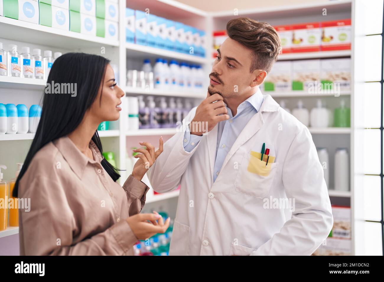 Man and woman pharmacist and client speaking at pharmacy Stock Photo ...