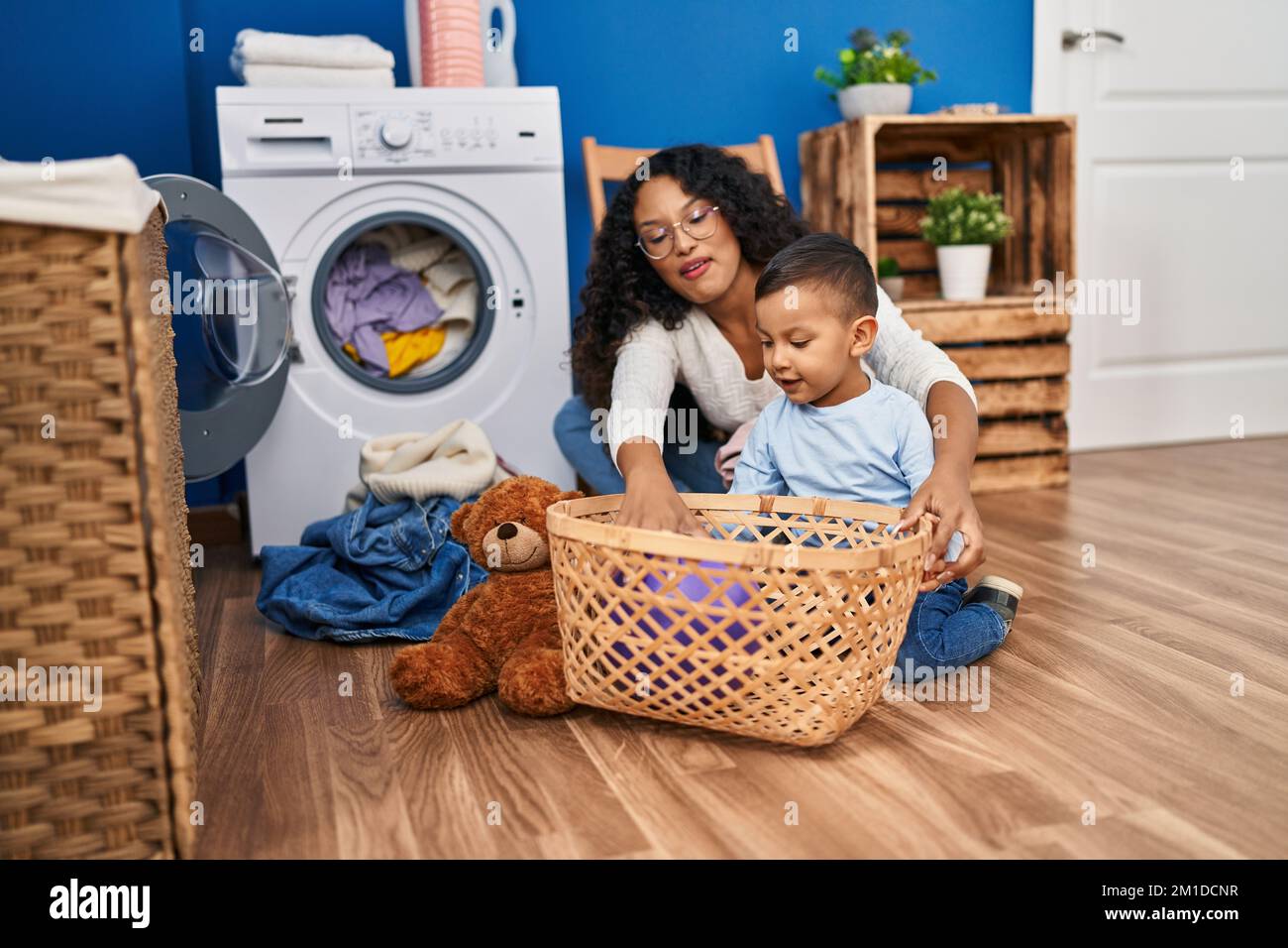 Mother and son smiling confident washing clothes at laundry room Stock ...