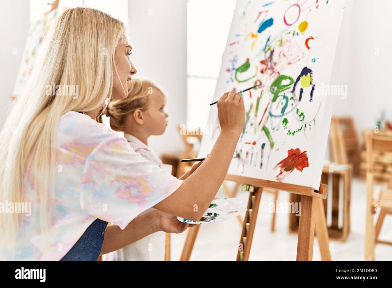 Mother and daughter smiling confident drawing at art studio Stock Photo ...