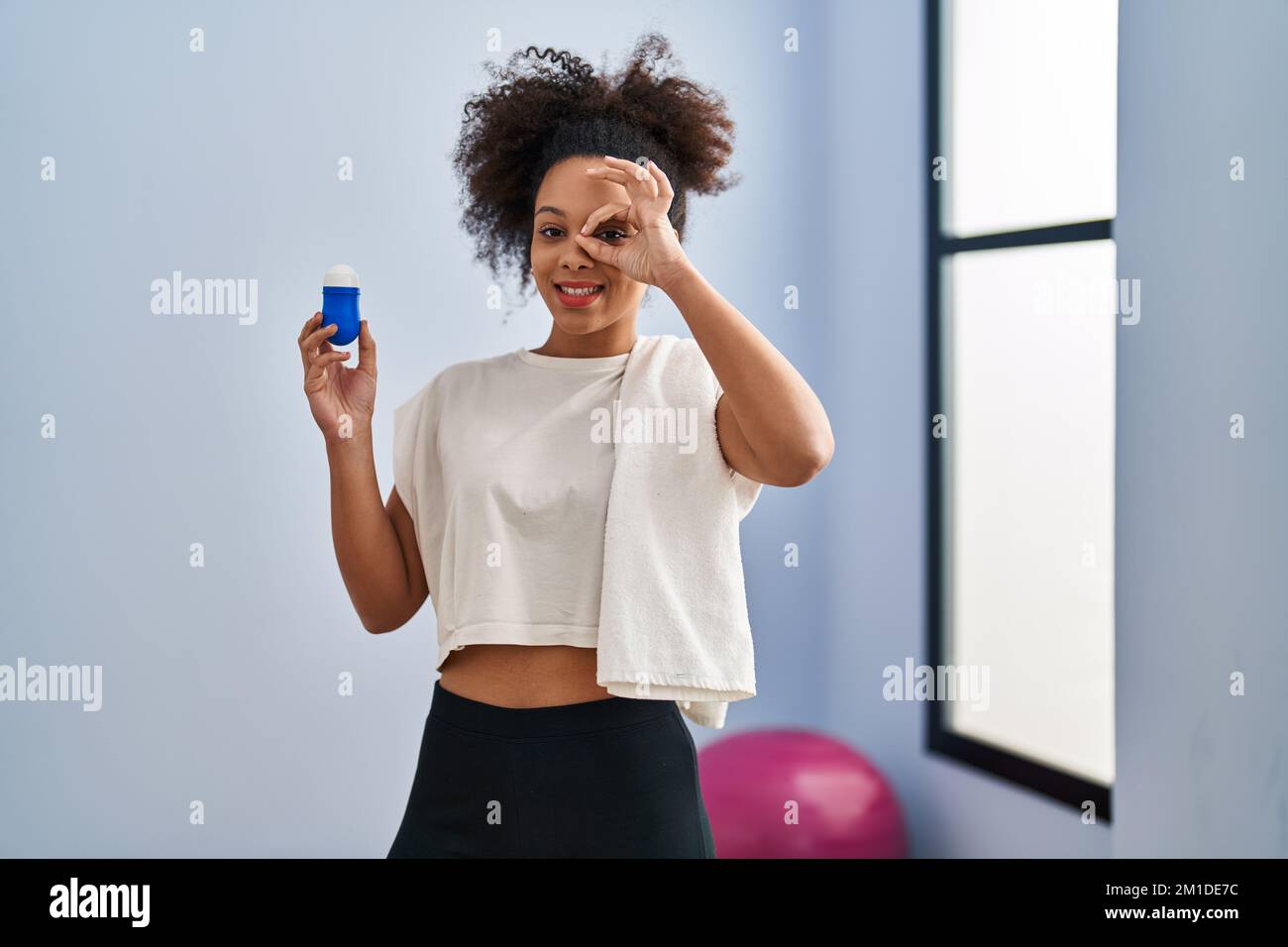 Young african american woman wearing sportswear and towel holding ...