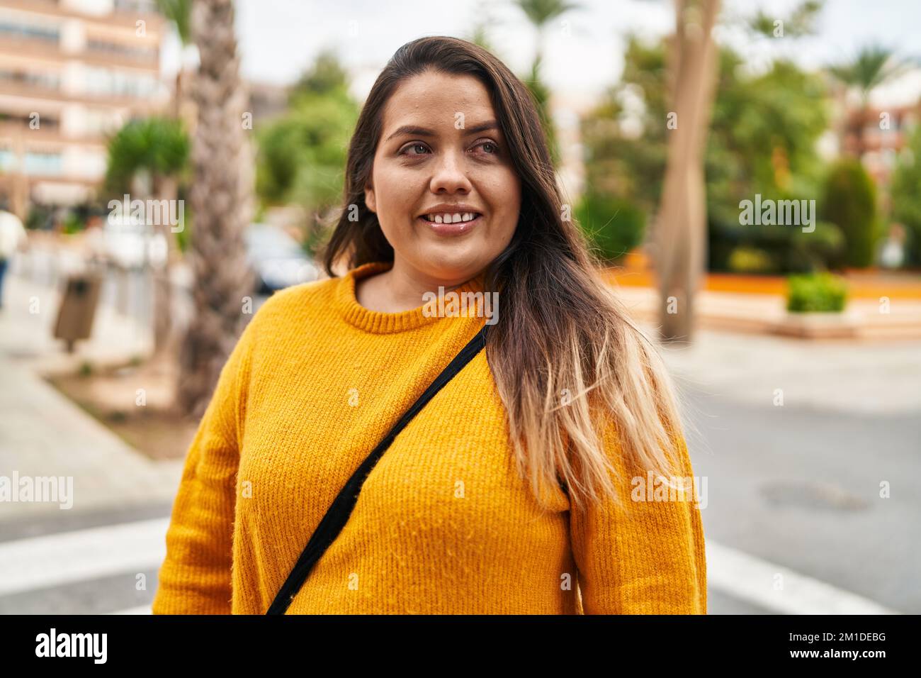Young beautiful plus size woman smiling confident looking to the side ...