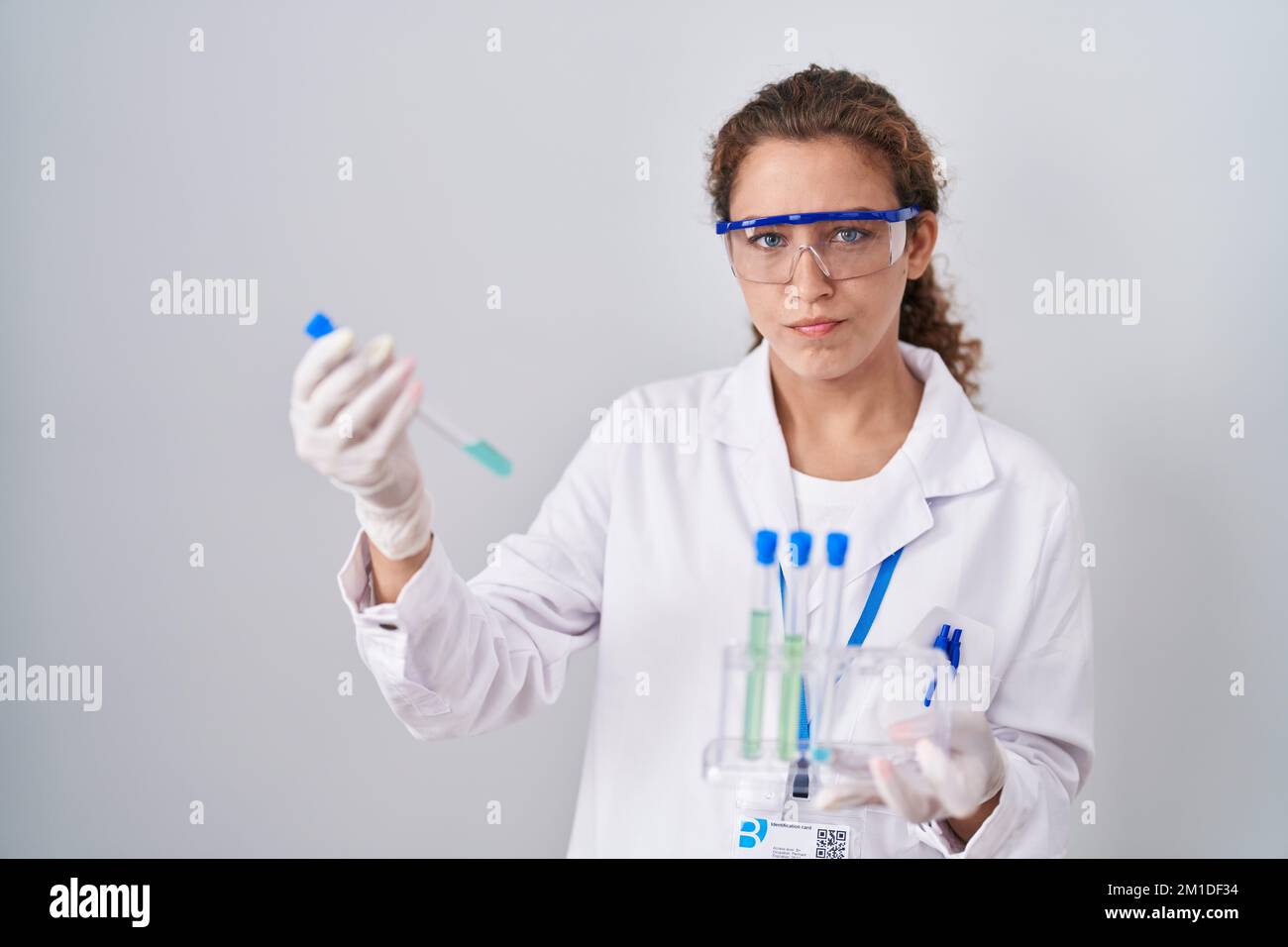 Young caucasian scientist woman working with laboratory samples skeptic ...