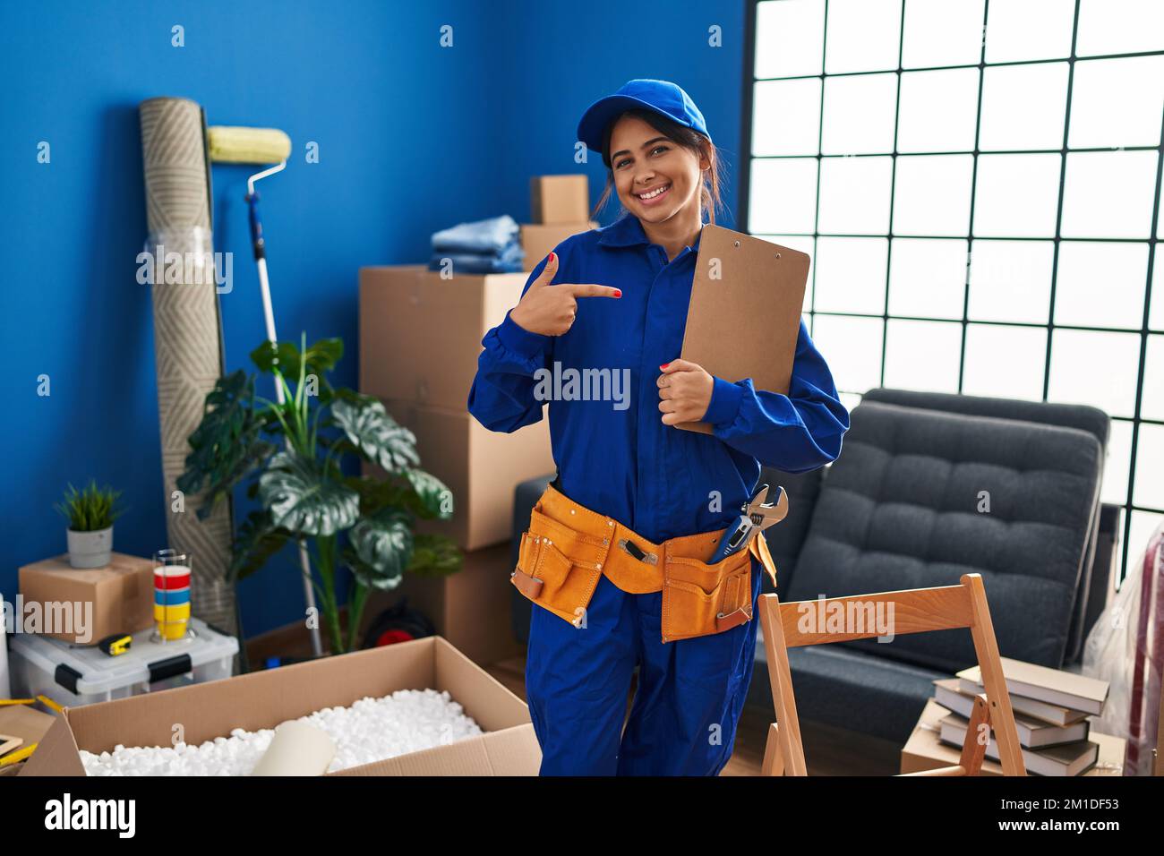 Young hispanic technician working at house renovation smiling happy ...