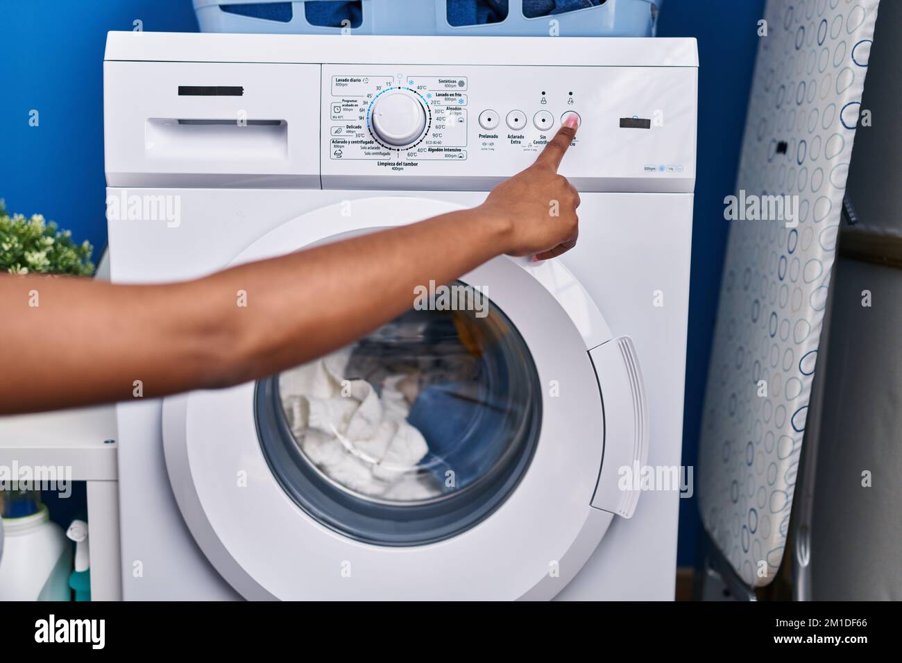 African american woman turning on washing machine at laundry room Stock ...