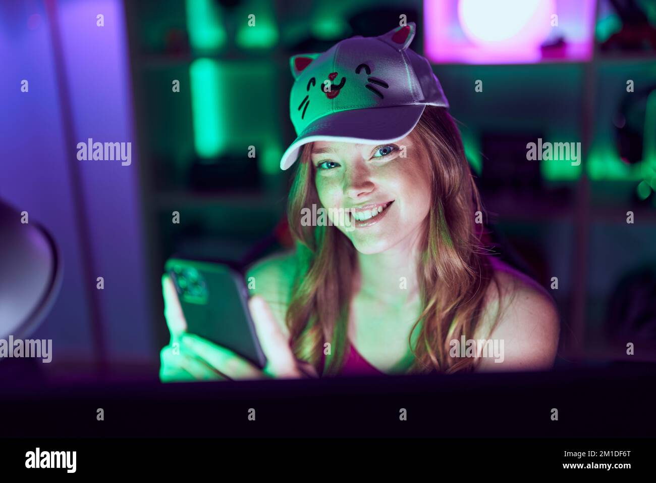 Young woman streamer using computer and smartphone at gaming room Stock ...