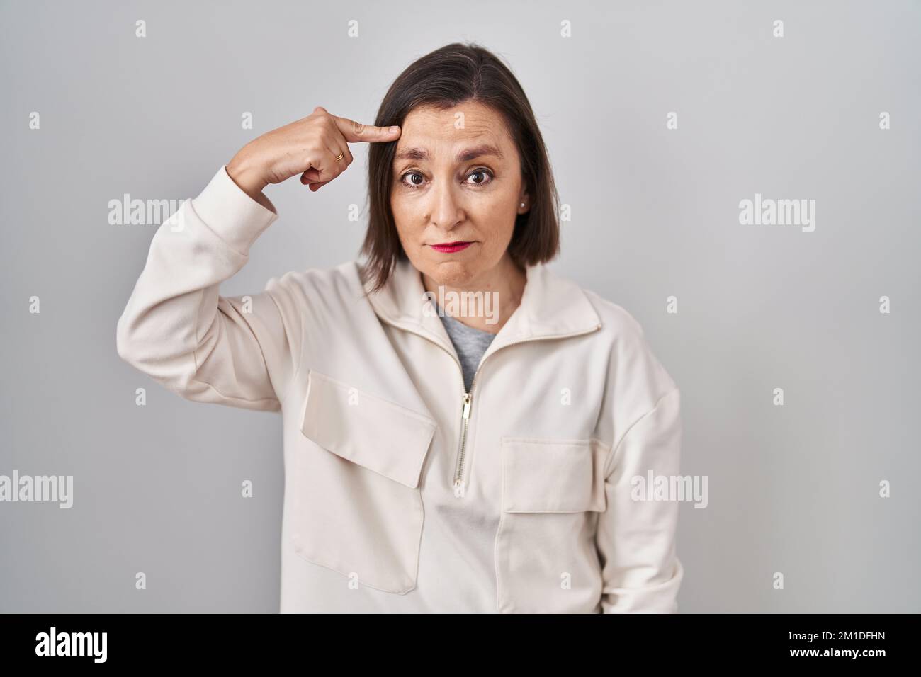 Middle age hispanic woman standing over isolated background pointing ...