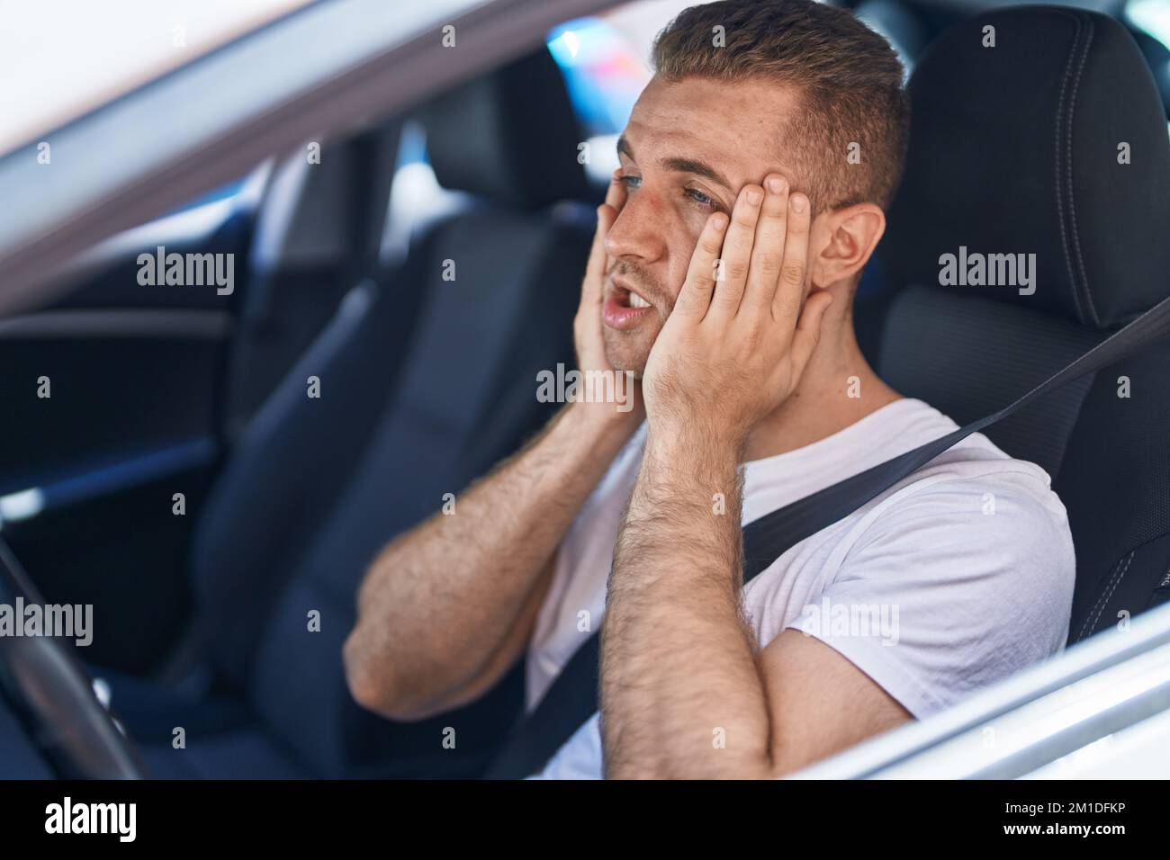 Young caucasian man stressed driving car at street Stock Photo - Alamy
