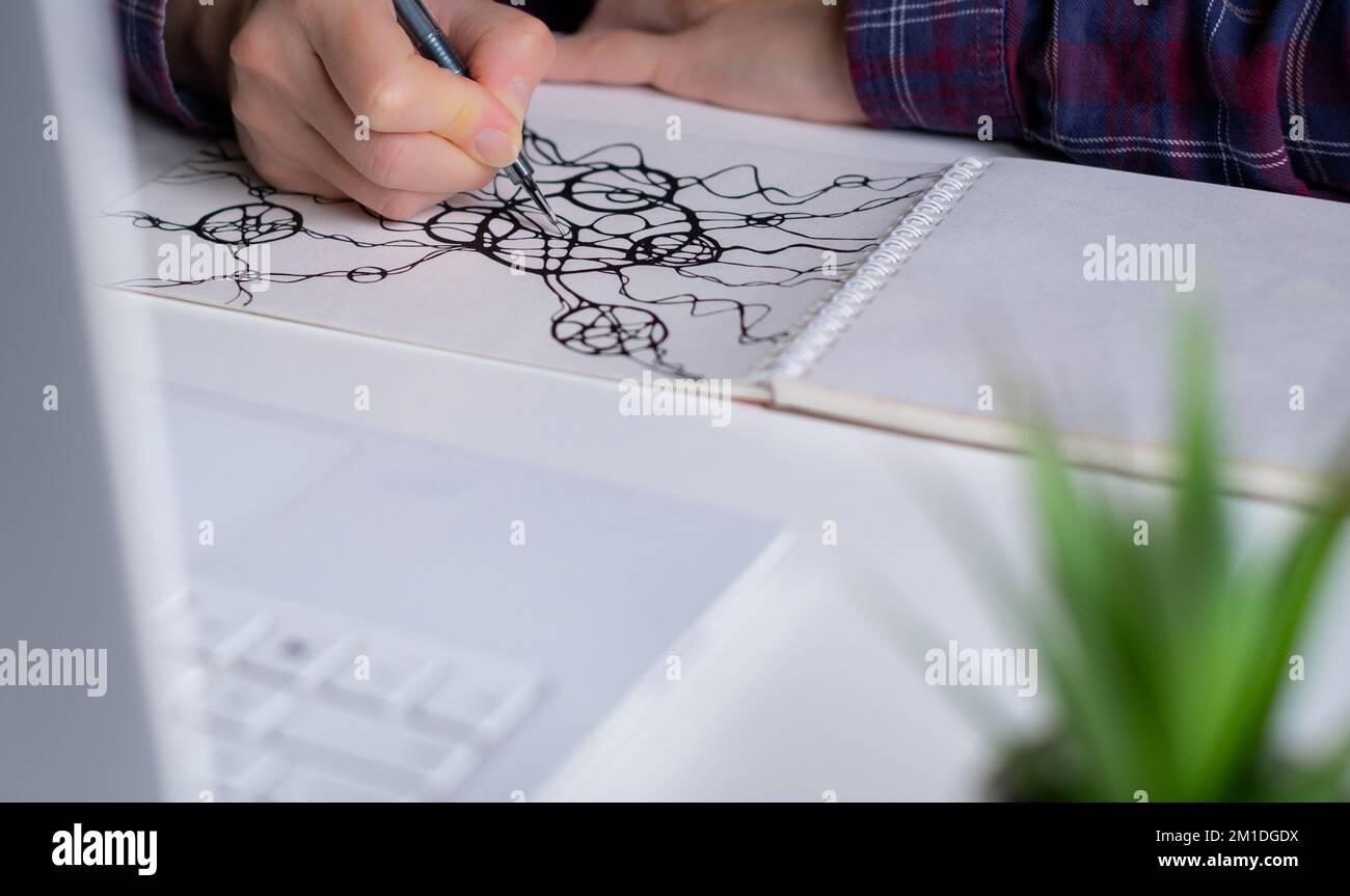 Abstract neurographic drawing with pen. Close-up of hands drawing ...