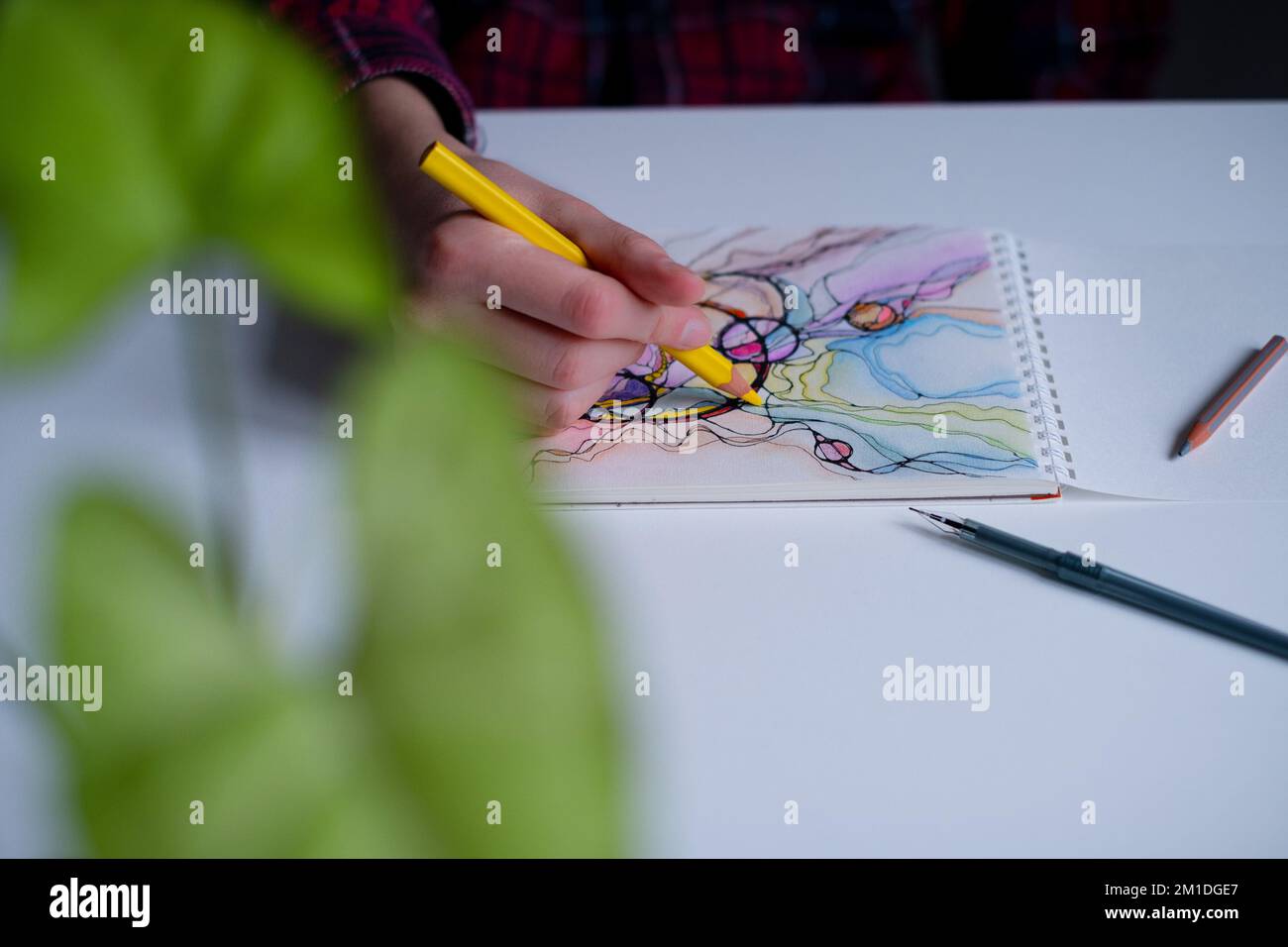 Abstract neurographic drawing with colored pencils. Close-up of hands ...