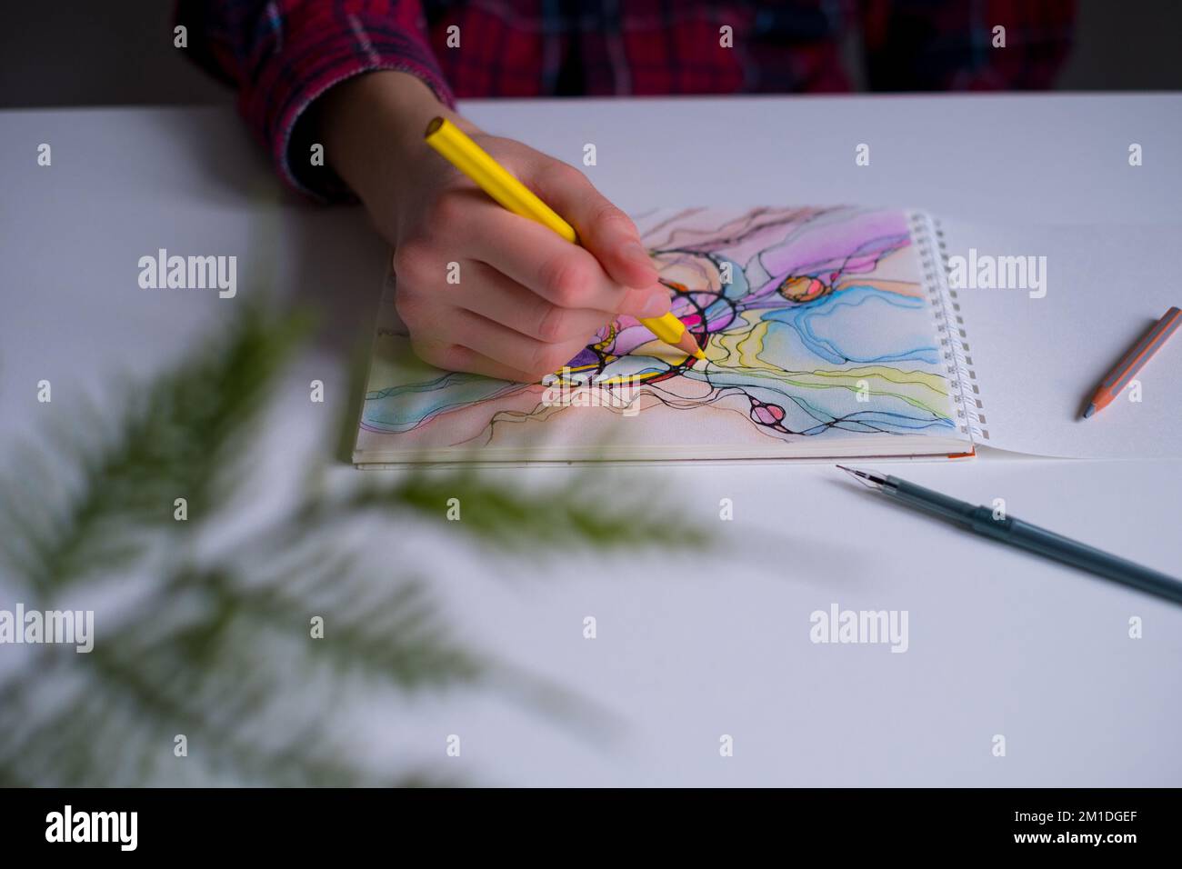 Abstract neurographic drawing with colored pencils. Close-up of hands ...