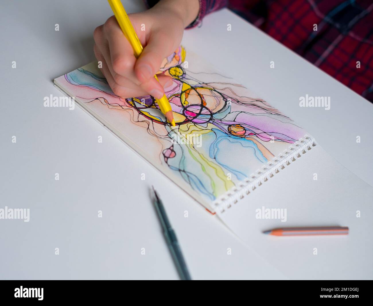 Abstract neurographic drawing with pen and colored pencils. Close-up of ...
