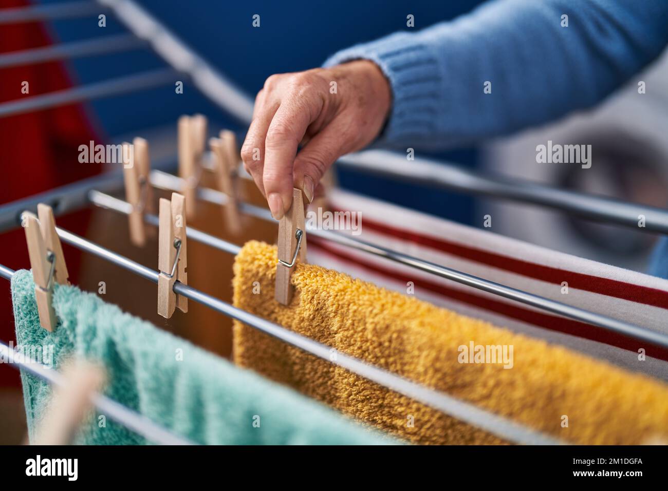 Middle age woman hanging clothes on clothesline at laundry room Stock ...