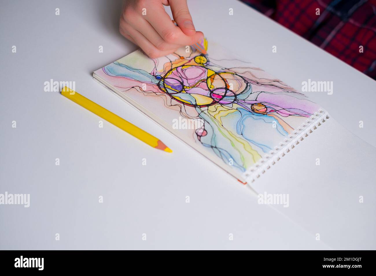 Abstract neurographic drawing with colored pencils. Close-up of hands ...