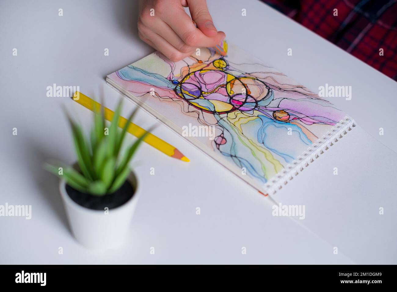 Abstract neurographic drawing with colored pencils. Close-up of hands ...