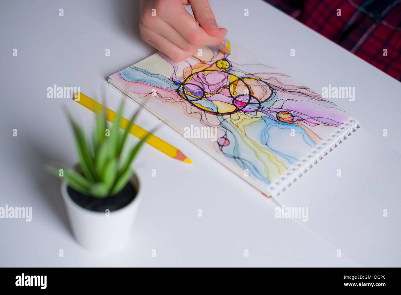 Abstract neurographic drawing with colored pencils. Close-up of hands ...