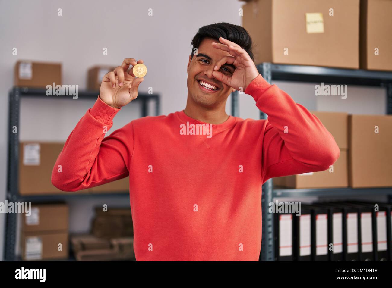 Hispanic man working at small business ecommerce holding bitcoin ...